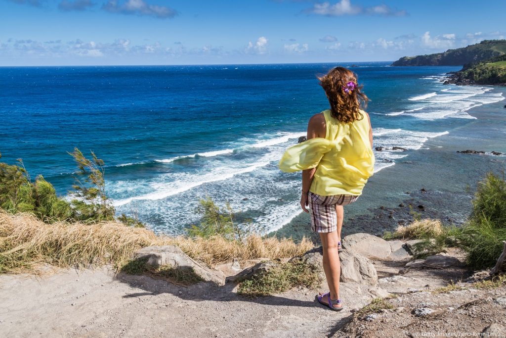 Woman overlooking Maui coast on her 5-Day Maui itinerary - pmimaui